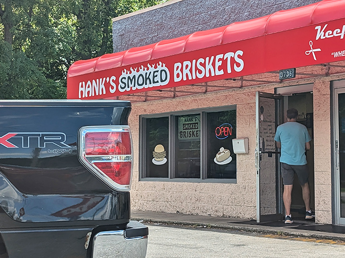 The bright red awning of Hank's stands out like a beacon for barbecue pilgrims, promising smoky salvation inside this unassuming Indianapolis treasure.