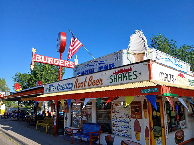 The Snow Cap's vibrant exterior is like a neon-lit time machine to the 1950s, complete with that iconic ice cream cone beckoning hungry travelers.