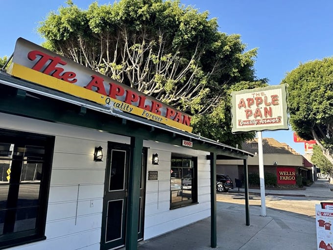 The unassuming white exterior of The Apple Pan stands like a time capsule on Pico Boulevard, its vintage sign promising "Quality Forever" &ndash; a bold claim they've been backing up since 1947.
