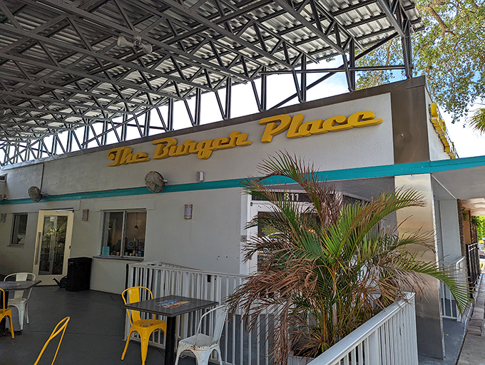Golden script lettering and palm trees create the perfect Florida diner entrance that whispers "great food ahead."