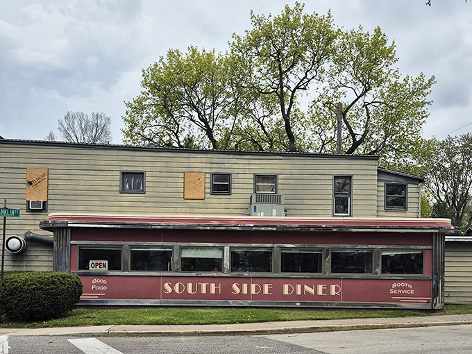 The classic red facade of South Side Soda Shop stands like a time capsule on Goshen's Main Street, complete with blue umbrellas that beckon hungry travelers to slow down and savor.