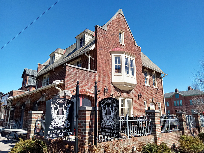 The stately brick exterior of Valter's welcomes visitors with colorful umbrellas, international flags, and blooming hydrangeas—Germany meets Midwest in architectural harmony.