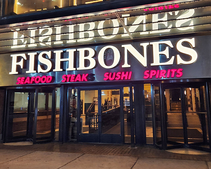 Fishbones announces itself with Vegas-worthy neon brilliance. The glowing sign promises seafood treasures within this Greektown hotspot.