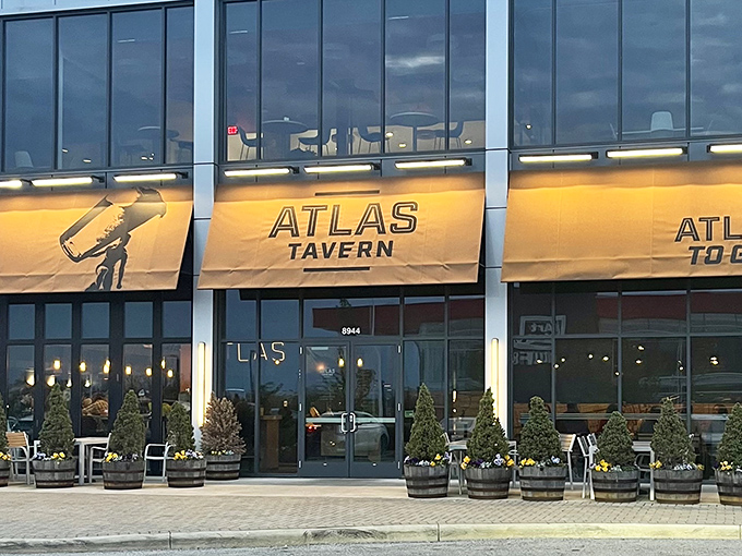 Atlas Tavern's distinctive yellow awnings beckon hungry travelers like a lighthouse guiding ships to harbor. Modern meets comfortable in this Columbus hotspot. 