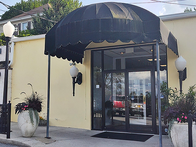 The entrance to Tavern on the Hill beckons like a culinary lighthouse, its elegant awning and warm glow promising delicious refuge from everyday dining disappointments.