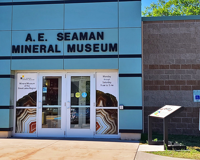 The modern exterior of the A.E. Seaman Mineral Museum beckons with colorful mineral images that hint at the geological wonders waiting inside.