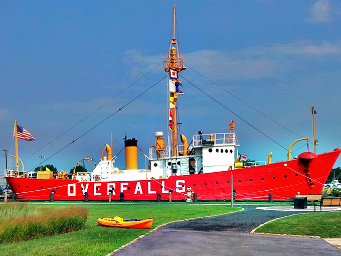 The Overfalls stands proudly along Lewes' Canalfront Park, its crimson hull practically shouting "Look at me!" to passersby enjoying their coastal stroll.