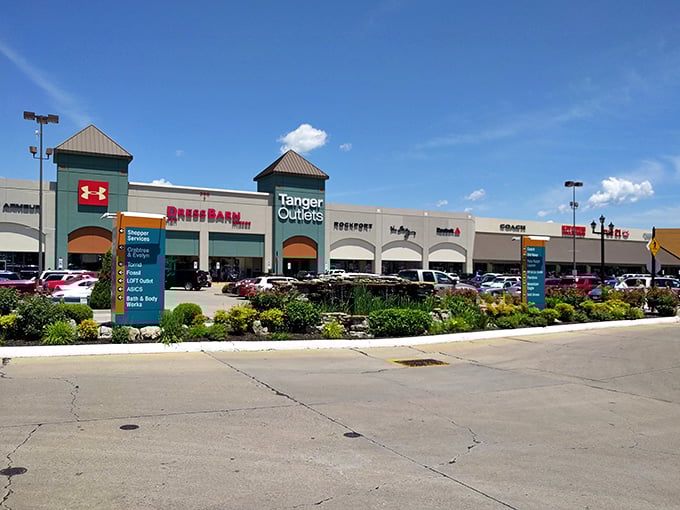 The retail promised land beckons with its iconic green tower. Dress Barn and Rockport stand ready to welcome bargain hunters into shopping paradise.