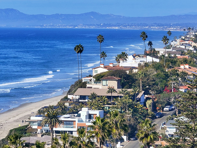 The iconic Encinitas sign welcomes you to paradise—where Spanish-style architecture meets surf culture and the clock permanently reads "chill o'clock."
