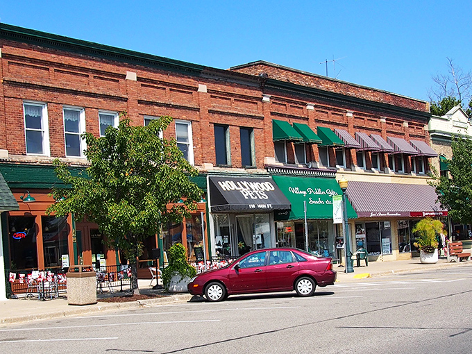 Classic brick storefronts line Brooklyn's charming main street, where racing excitement meets small-town serenity perfectly.