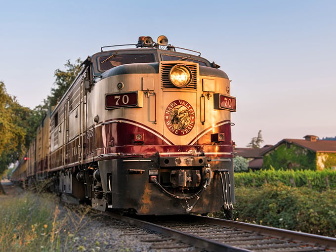 The iconic burgundy and cream locomotive stands ready for adventure, a gleaming time machine that transports passengers through California's most delicious landscape.