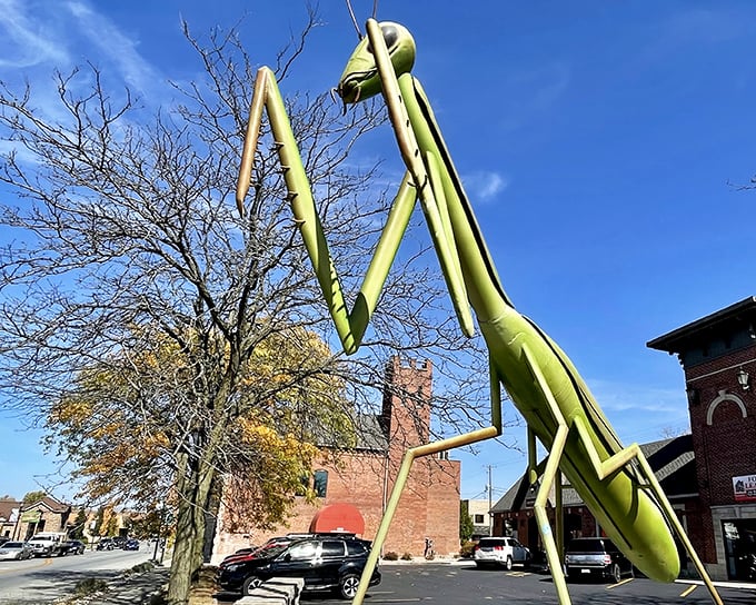 The KokoMantis stands tall against the Indiana sky, like a lime-green sentinel guarding downtown Kokomo with its otherworldly presence.