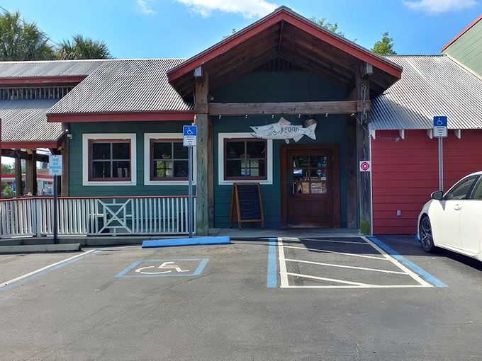 The mint-green exterior with its weathered "Grads and Dads Love Shrimp" sign promises Florida seafood authenticity without pretense. No designer consultants were harmed in the making of this restaurant.