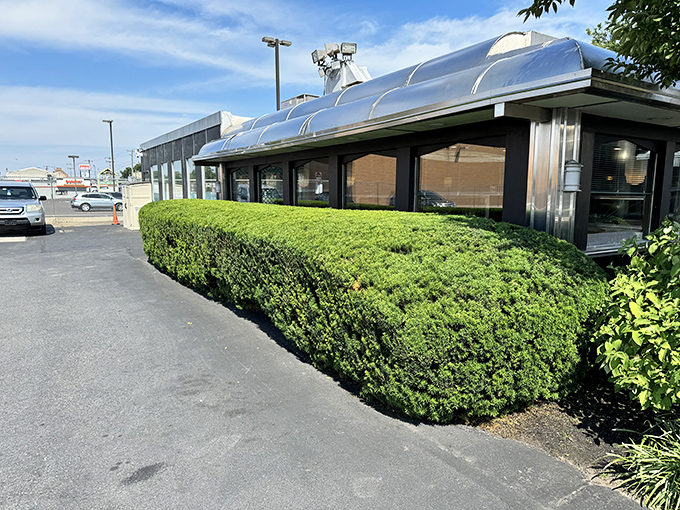 The neon-trimmed exterior of The Dining Car glows like a time machine to the golden age of American diners, beckoning hungry travelers day and night.