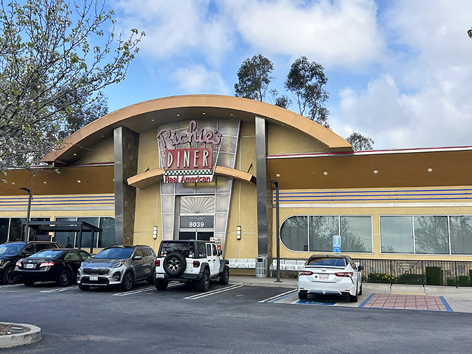 The curved, retro-modern facade of Richie's Diner beckons like a time machine disguised as a restaurant. Step inside and leave your diet at the door.