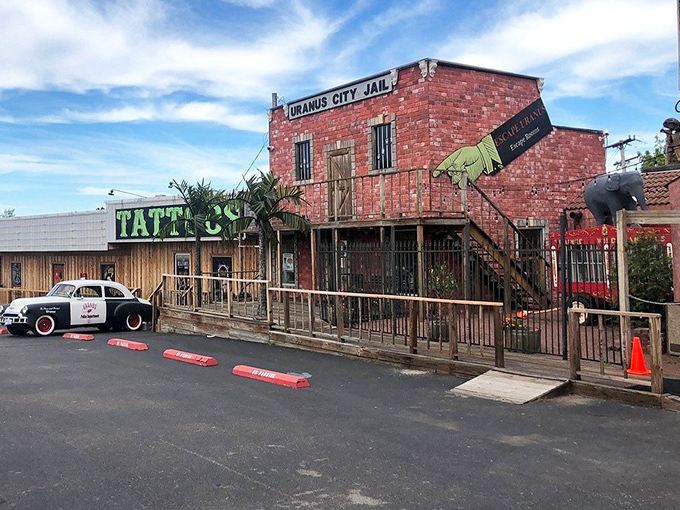 The Wild West meets roadside kitsch at Uranus City Jail, where palm trees and wooden boardwalks create an unexpected Missouri frontier experience.