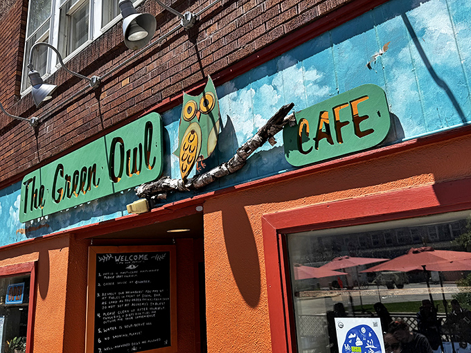 The vibrant turquoise facade of The Green Owl Cafe stands out like a cheerful oasis on Atwood Avenue, complete with its whimsical owl mascot.
