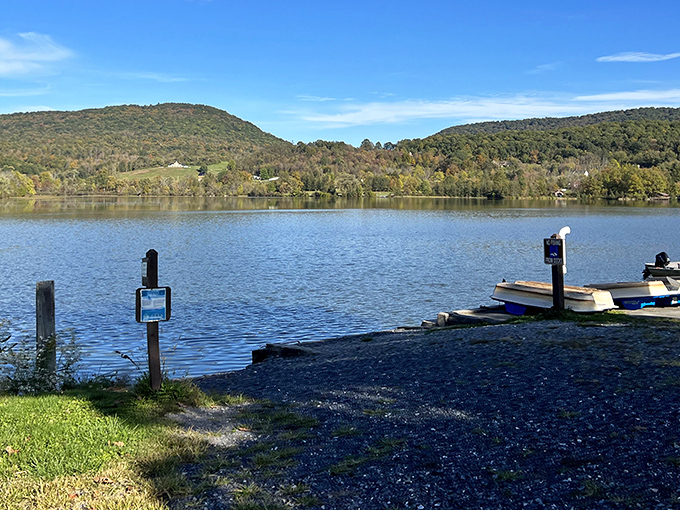 The perfect mirror-like waters of Canoe Lake reflect Pennsylvania's rolling hills, creating nature's own double feature. Boat dock awaits your adventure.