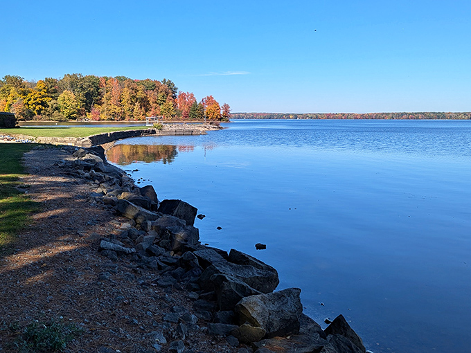 Mirror-like waters stretch to the horizon under an impossibly blue sky, with autumn's golden touch adding a perfect splash of color. Nature showing off its best side.