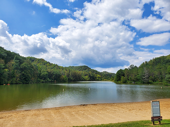 Nature's perfect postcard moment: a rustic wooden pier stretches into Dow Lake's calm waters, while autumn begins painting the surrounding hillsides with its artistic touch.
