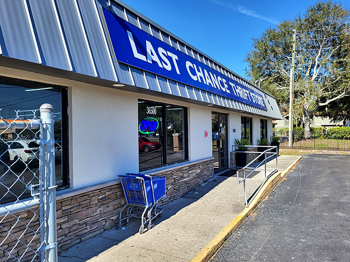The blue awning beckons like a portal to treasure-hunting paradise. Last Chance Thrift Store's unassuming exterior hides a wonderland of possibilities within.