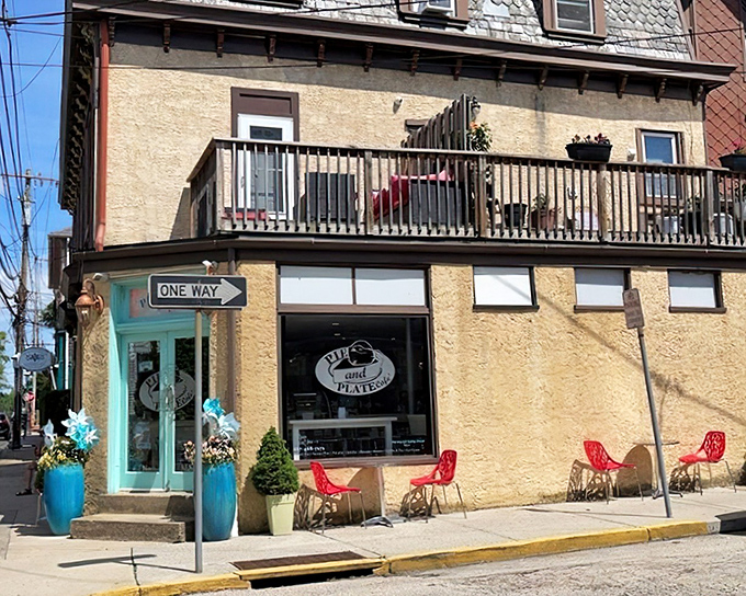 Corner charm at its finest! Pie and Plate Cafe's inviting exterior with turquoise door and bright red chairs beckons pie enthusiasts from Ambler's bustling streets.