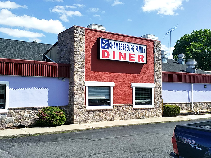 The iconic red and stone exterior of Sunrise Diner stands as a beacon for hungry travelers. Classic Americana at its finest!