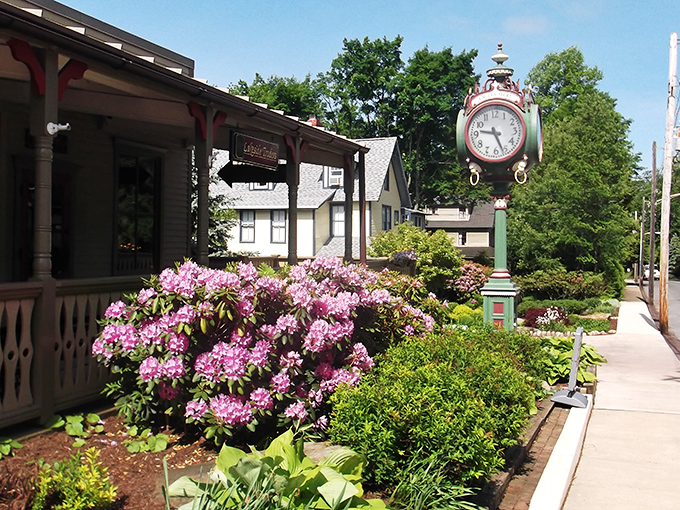 Downtown Eagles Mere showcases its timeless charm with a vintage clock standing sentinel among blooming rhododendrons &ndash; small-town Americana at its picture-perfect best.