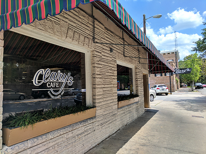 The colorful striped awning of Clary's Cafe isn't just eye-catching—it's practically a beacon for breakfast enthusiasts wandering Savannah's historic streets.