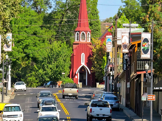 The iconic red church stands like a crimson exclamation point amid Sonora's lush greenery, a postcard-perfect scene that whispers "small-town charm" at full volume.