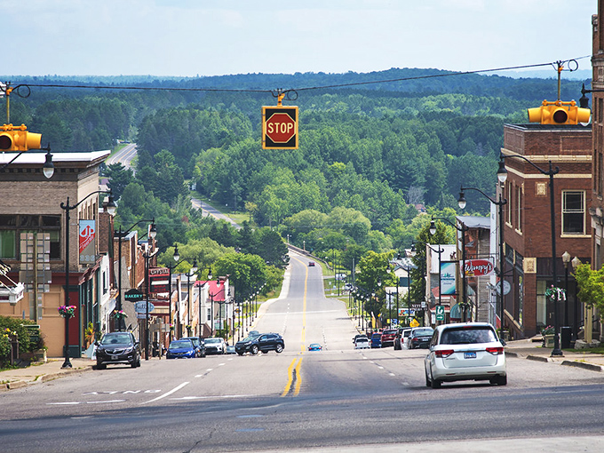 Superior Avenue stretches into the distance like a postcard from simpler times, framed by forests that seem to whisper, "Slow down, you're home now."
