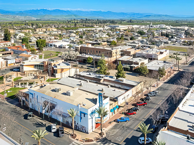 Panoramic perfection! Lindsay's downtown basks under Sierra Nevada's watchful gaze, where small-town charm meets big mountain views.