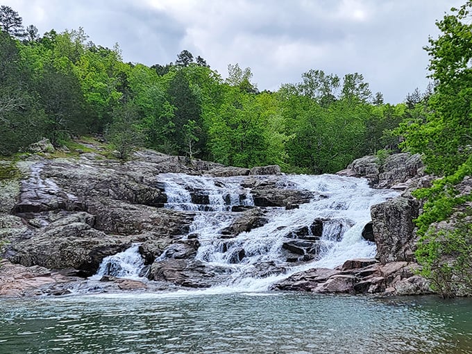 Nature's perfect staircase cascades over billion-year-old rhyolite rock. Missouri showing off with water ballet that would make Esther Williams jealous.