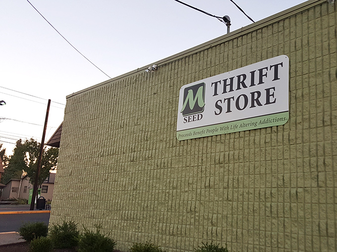 The distinctive green "M" sign welcomes treasure hunters to this unassuming storefront where fashion meets compassion and every purchase powers community recovery programs.