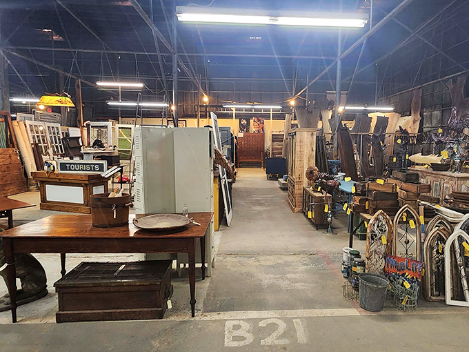 Treasure hunter's paradise! Aisle B21 beckons with weathered wood tables, architectural salvage, and that vintage sign practically screaming "take me home to your guest room."