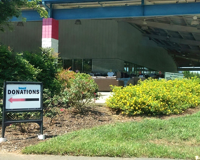 The donation drop-off area welcomes generous souls with cheerful yellow landscaping. Your castoffs become someone else's treasure hunt starting right here.