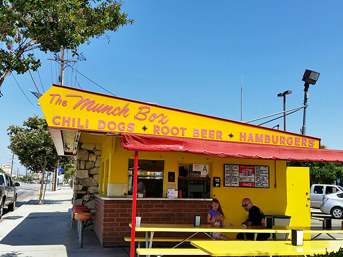 The sunshine-yellow landmark stands proudly in Chatsworth, its red awning and picnic tables inviting hungry patrons to experience a slice of California fast-food history.