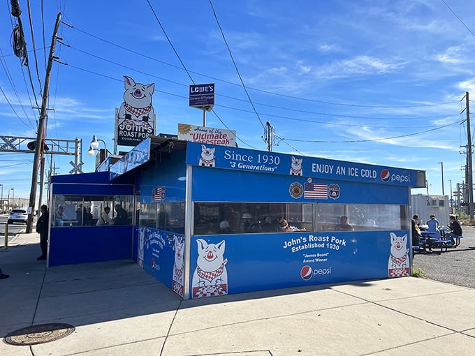 The bright blue exterior of John's Roast Pork stands out like a culinary lighthouse, guiding hungry souls to sandwich nirvana since 1930.