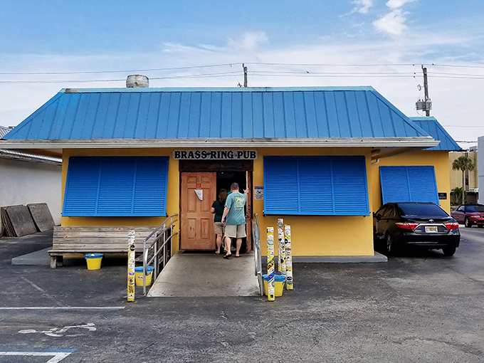 The unassuming blue-roofed exterior of Brass Ring Pub stands like a culinary lighthouse, beckoning burger pilgrims with the promise of greatness within.