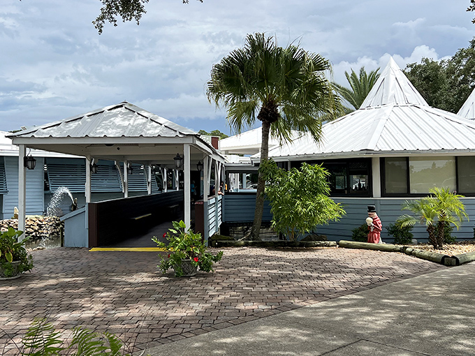 The unassuming blue exterior of Dixie Crossroads hides seafood treasures within, like a pirate's chest disguised as a beach cottage.