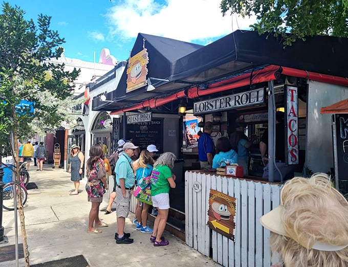 The line forms early at DJ's Clam Shack, where Key West visitors patiently wait for lobster roll nirvana under the tropical sun.