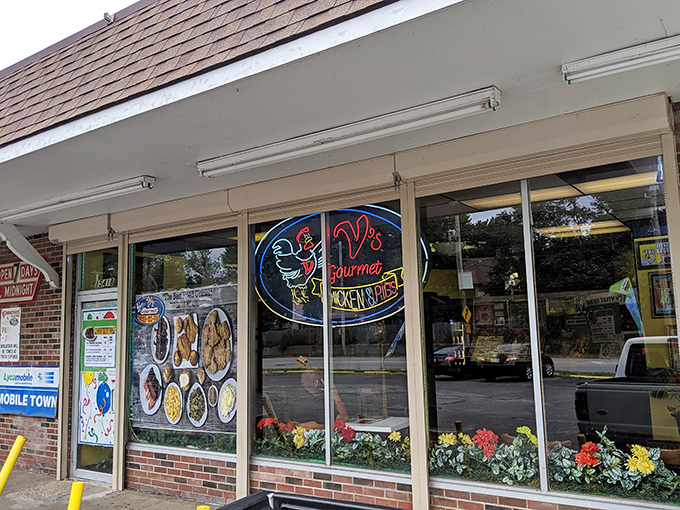 The unassuming storefront of V's Gourmet Chicken might not win architectural awards, but those yellow bollards are guarding culinary treasure that locals have cherished for years.