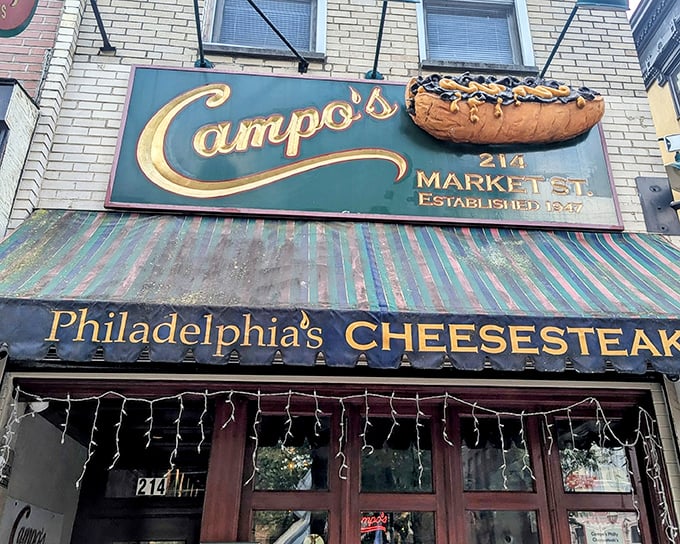 Campo's iconic storefront beckons with its giant cheesesteak sign &ndash; like a meaty lighthouse guiding hungry souls through Philadelphia's historic streets.