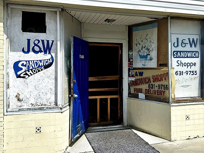 That blue door isn't just an entrance – it's a portal to sandwich nirvana, where J&W's humble exterior belies the flavor treasures waiting inside.