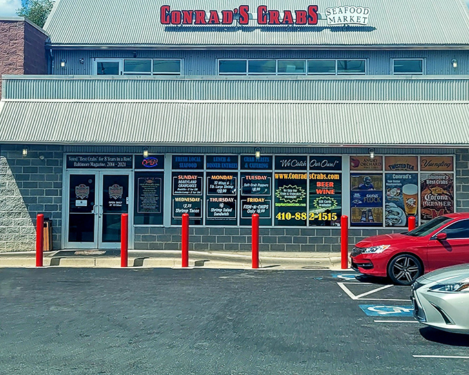 The unassuming exterior of seafood paradise – where Maryland's best crabs hide behind a humble façade and those red bollards stand guard like sentinels protecting treasure.