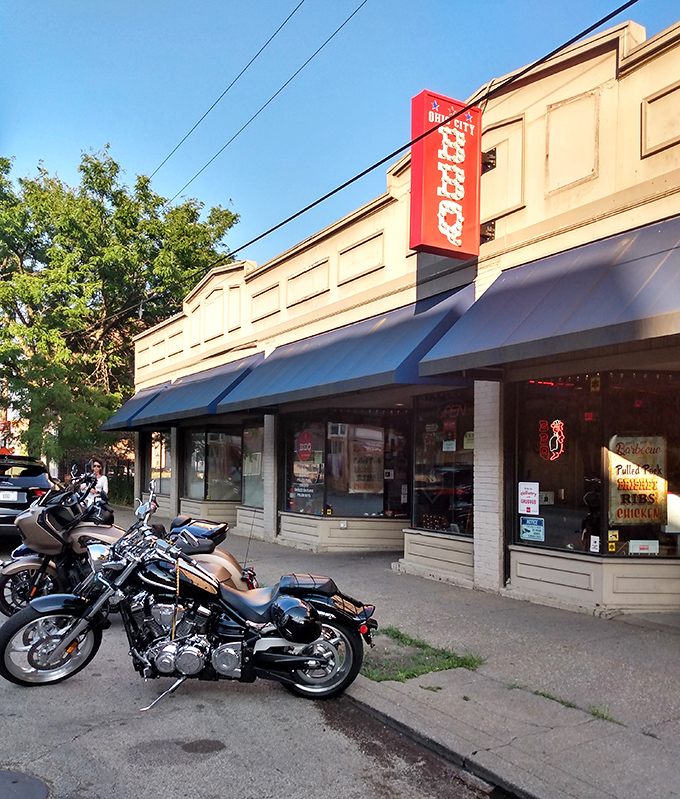 The unassuming exterior of Real Smoq'ed BBQ gives no hint of the flavor explosion waiting inside. Blue awnings and a simple storefront hide Cleveland's best-kept barbecue secret.