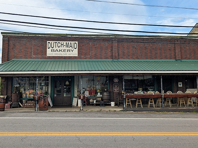 The brick facade of Dutch Maid Bakery & Cafe stands proudly in Tracy City, its green awning like a welcome flag to hungry travelers seeking authentic Tennessee flavors.