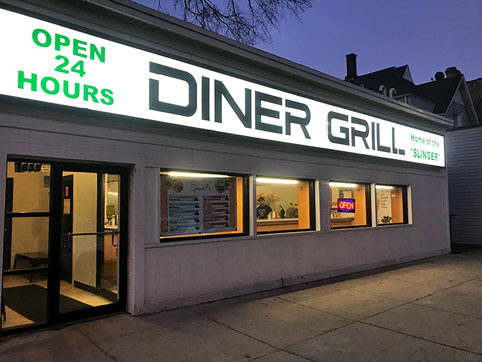 The neon "OPEN 24 HOURS" sign glows like a lighthouse for hungry night owls, promising salvation in the form of perfectly griddled comfort food.