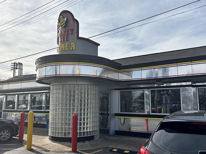 The iconic Honey Bee Diner exterior gleams like a beacon of breakfast hope on Ritchie Highway, its cheerful bee mascot promising sweet satisfaction ahead.