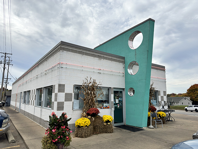 That iconic turquoise fin jutting skyward isn't just architectural flair—it's a beacon calling hungry travelers to a genuine slice of Americana in Alliance.